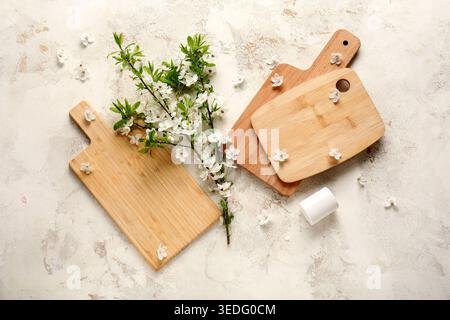 Different wooden cutting boards with beautiful blooming tree branches ...