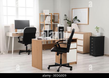 Interior of office with desks, shelf unit and shredder Stock Photo - Alamy