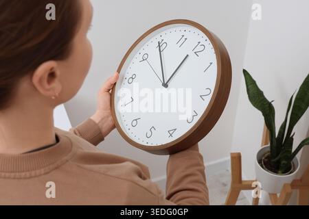 Woman changing clock for daylight saving time at home, closeup Stock ...