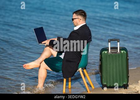 Sea office shows remote working. Man working remotely near water ...