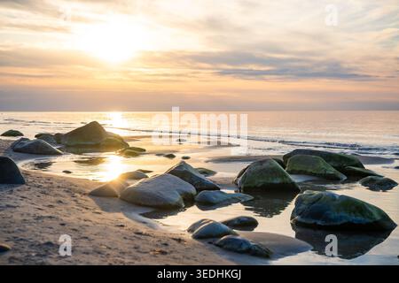 Rocky beach coastline on Ruegen island in Germany during sunset over ...
