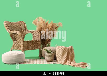 Wicker armchair with pampas grass and rug on beige background Stock ...