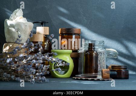 Scented candles and jars with essential oil. Dried lavender ...