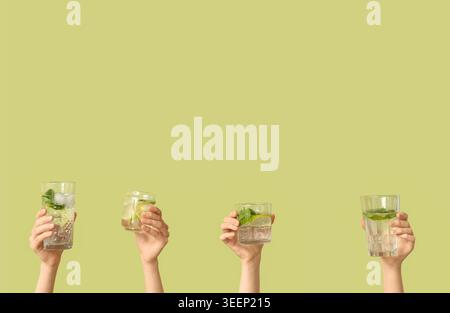 Female hands with different glasses of mojito on green background Stock ...