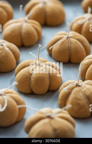 Pumpkin spice bread buns, shaped like small pumpkins and tied with ...