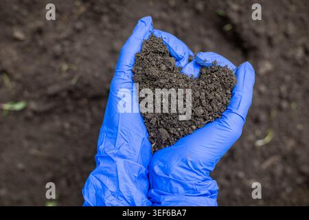 Dark fertile soil texture close up with natural organic ground and ...