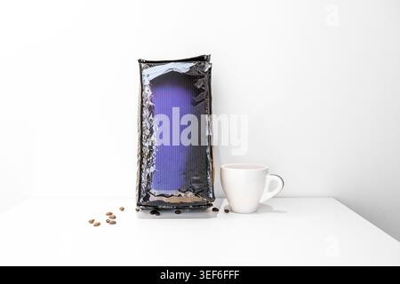 A dark green airtight box with coffee beans on a white surface Stock ...