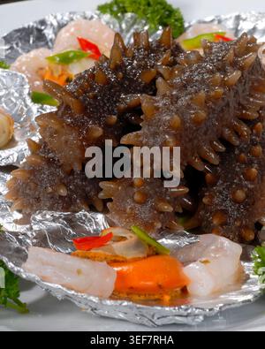 Premium Chinese sea cucumber and shrimp dumplings Jiaozi on black plate ...