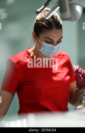 Female dentist with dental tools on blue background. World Dentist Day ...