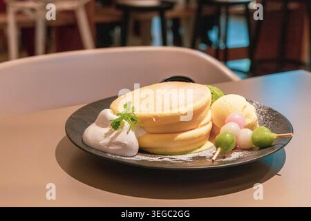 Colorful Japanese mochi dessert topped with fresh strawberries, styled ...