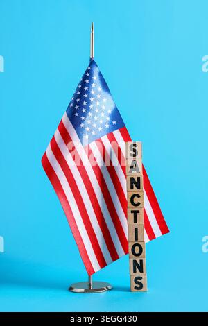 Cubes with word SANCTIONS on blue background Stock Photo - Alamy