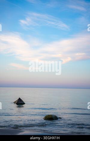 Calm sea horizon on Ruegen island in Germany during evening light over ...