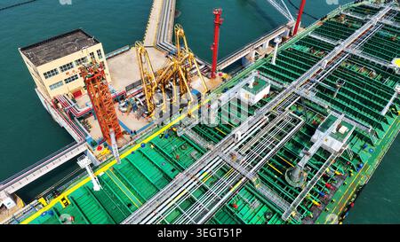 A tanker unloads imported crude oil at the oil terminal of Qingdao Port ...