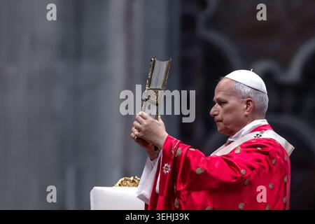 Pope Leo XIV holds the gospel during a Mass for the Solemnity of ...