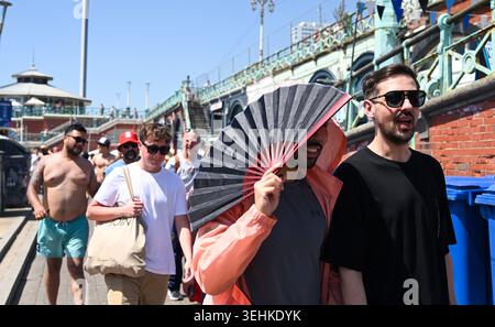 A visitor tries to stay cool in the heat while attending the Great ...