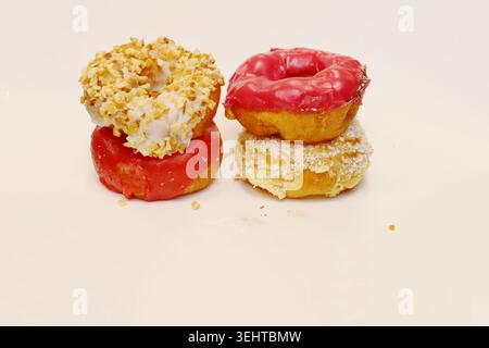 A round iced pastry topped with cookie crumbles and white drizzle sits ...