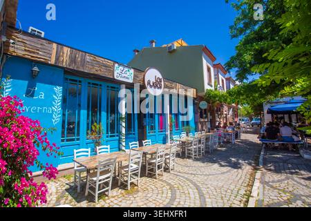 Ayvalik - Turkey, May 17, 2026, Stone houses and taverns in the back ...
