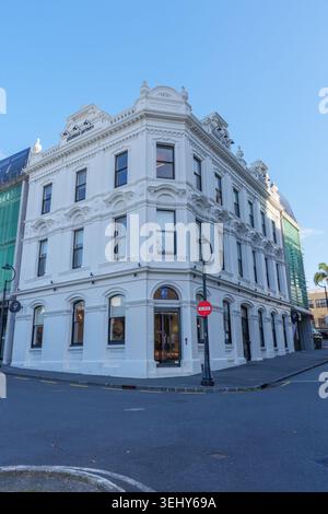 Auckland New Zealand - May 7 2026; Woman in red trousers walks past and ...