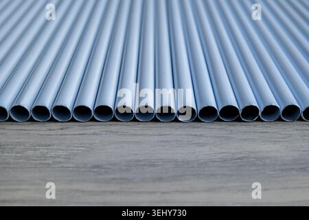 Row of light blue PVC pipes on concrete surface Stock Photo - Alamy