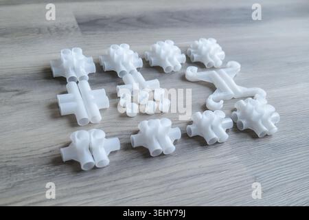White Plastic Connectors for DIY Projects on Wooden Background Stock ...