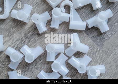 White Plastic Connectors for DIY Projects on Wooden Background Stock ...