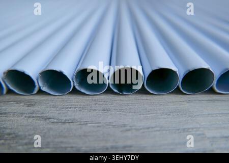 Row of light blue PVC pipes on concrete surface Stock Photo - Alamy