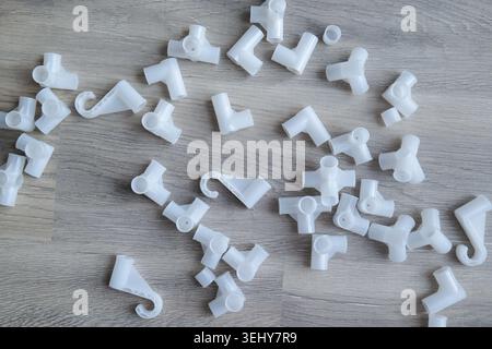 White Plastic Connectors for DIY Projects on Wooden Background Stock ...