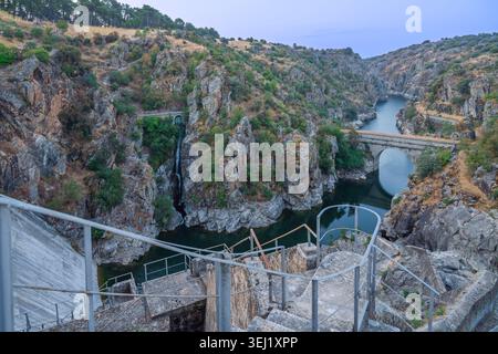 The road rises slightly above a narrow passage between reservoirs ...