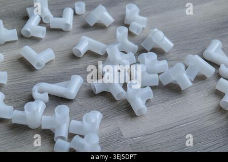 White Plastic Connectors for DIY Projects on Wooden Background Stock ...