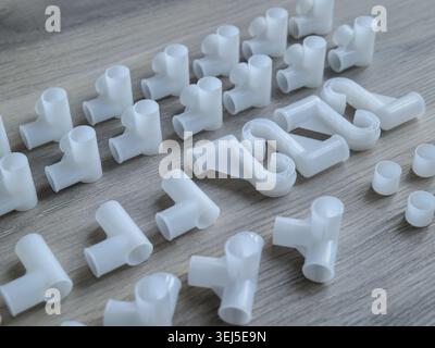 White Plastic Connectors for DIY Projects on Wooden Background Stock ...