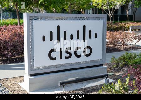 Cisco logo sign in landscaped area outside modern glass office building ...