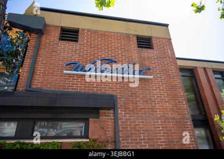Exterior brick wall of Waterbar restaurant with blue sign on a sunny ...