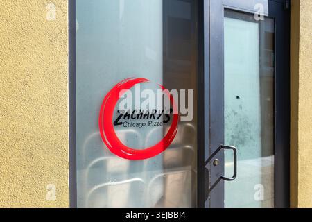 Entrance door with Zacharys Chicago Pizza logo on frosted glass in a ...