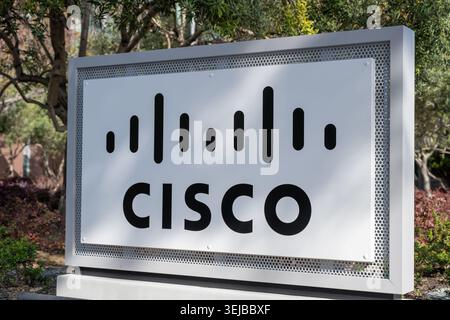 Cisco logo sign in landscaped area outside modern glass office building ...
