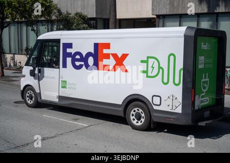 FedEx electric delivery van with sustainability branding parked on city ...