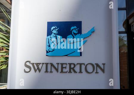 Swinerton construction company logo and signage on exterior column of a ...