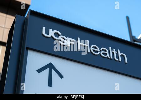 Directional sign with UCSF Health logo and arrow against blue sky, San ...