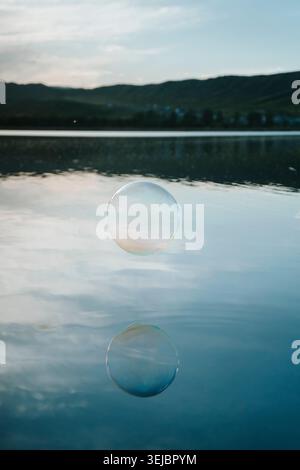 Minimalist Soap Bubble Floating Above Calm Lake Water Symbolizing ...
