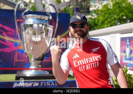 An Arsenal fan near Deak Ferenc Square in Budapest has a picture taken ...