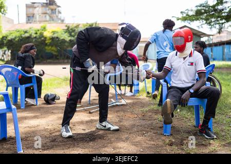 Head coach, Martin Musili seen taking a member of Kenya’s para fencing ...