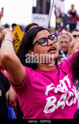 A protestor chants "fight back" during a demonstration march through ...