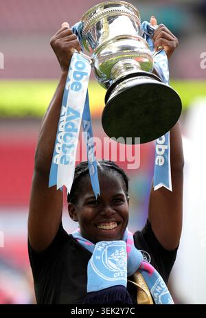 Khadija Shaw of Manchester City lifts the trophy after winning the ...