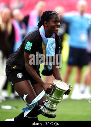 Khadija Shaw of Manchester City lifts the trophy after winning the ...
