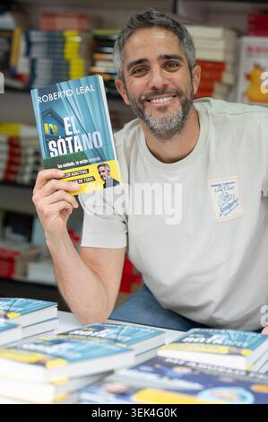 Author Roberto Leal signs copies of her books during the 85th edition ...