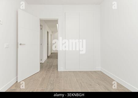 A clutter-free room with a built-in wardrobe in an ash gray tone ...