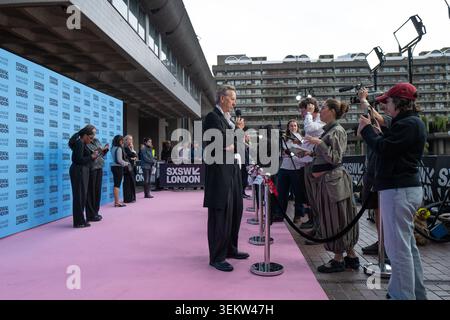 Richard E. Grant being interviewed by the press at the Savage House ...