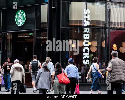 Starbucks logo is seen as people walk in front of the shop on landmark ...