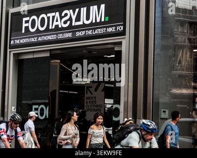 Footasylum logo is seen as people walk in front of the shop on landmark ...