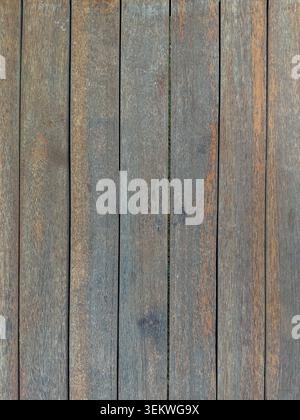 Weathered vertical wooden deck planks with screws and prominent grain ...