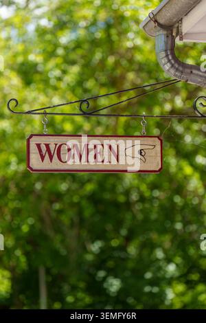 Sign indicating the location of an accessible restroom within a public ...